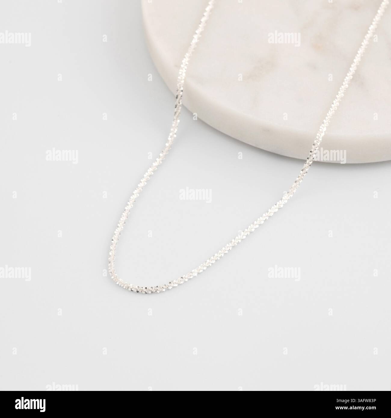 Elegant silver chain on a white background. Jewelry catalog Stock Photo ...