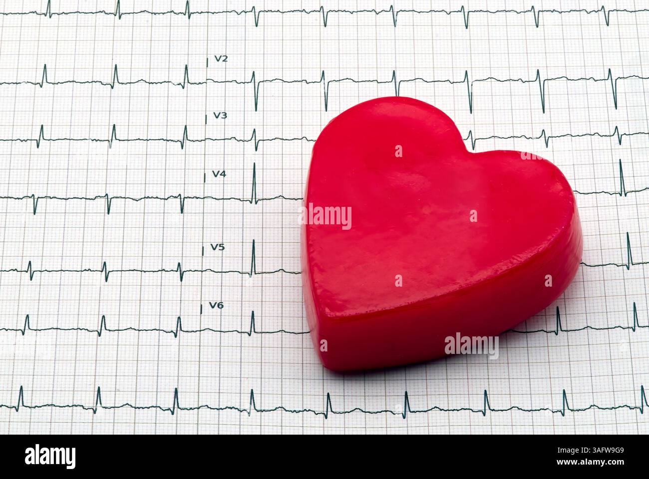 Heart shaped object on a standard electrocardiogram, ekg, graph paper ...