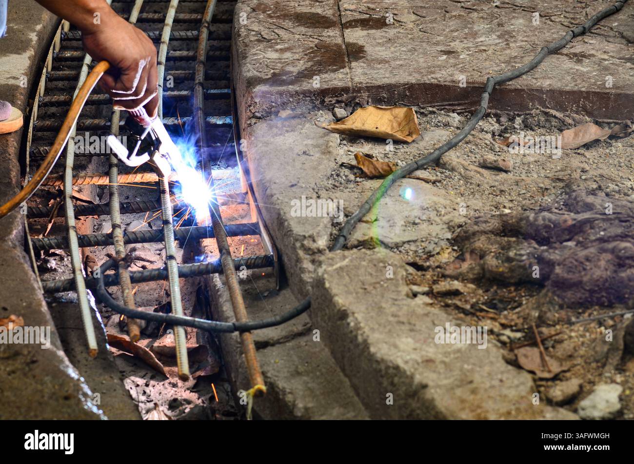 Connect the drainage grating with electricity weld Stock Photo - Alamy