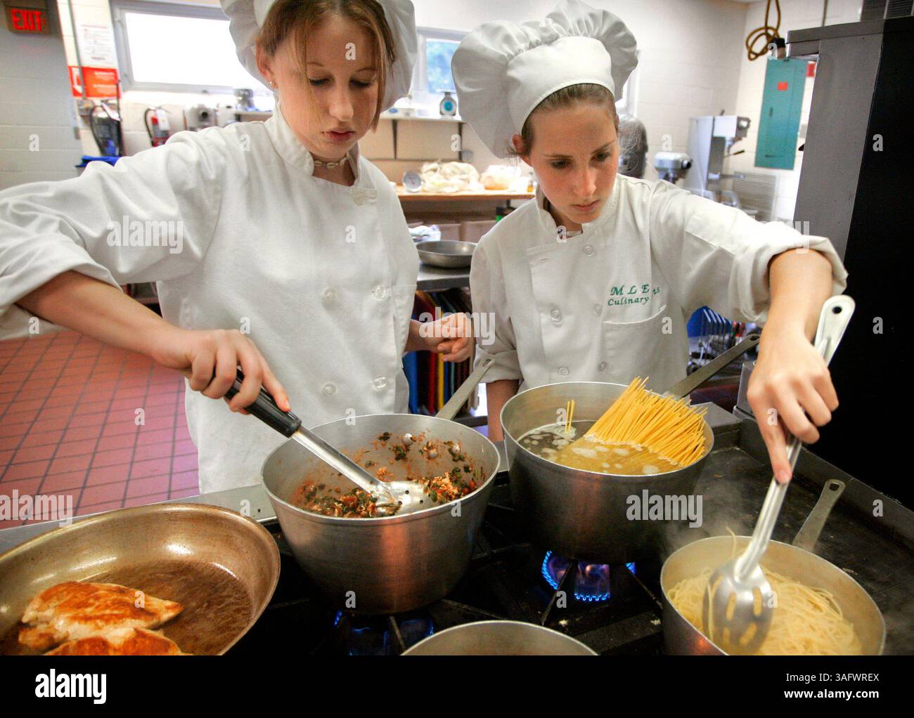 CAPTION: 04/18/2007 Dade City) ..Meghan Brownlee, left, cooks a meaty ...