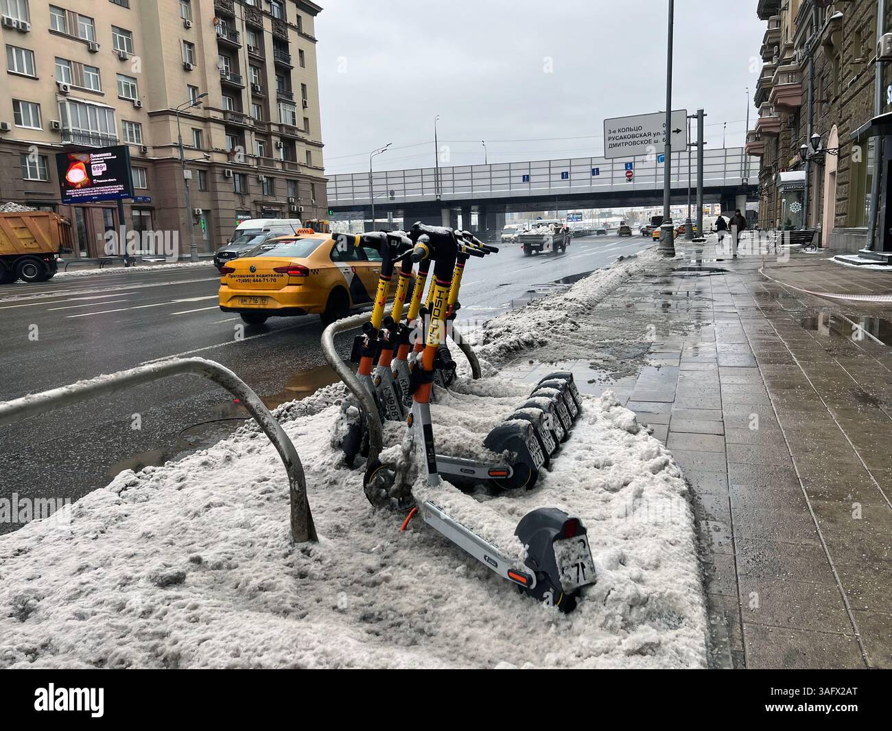 Moscow, Russia.7th April 2025. Snow-covered e-scooters are seen along ...