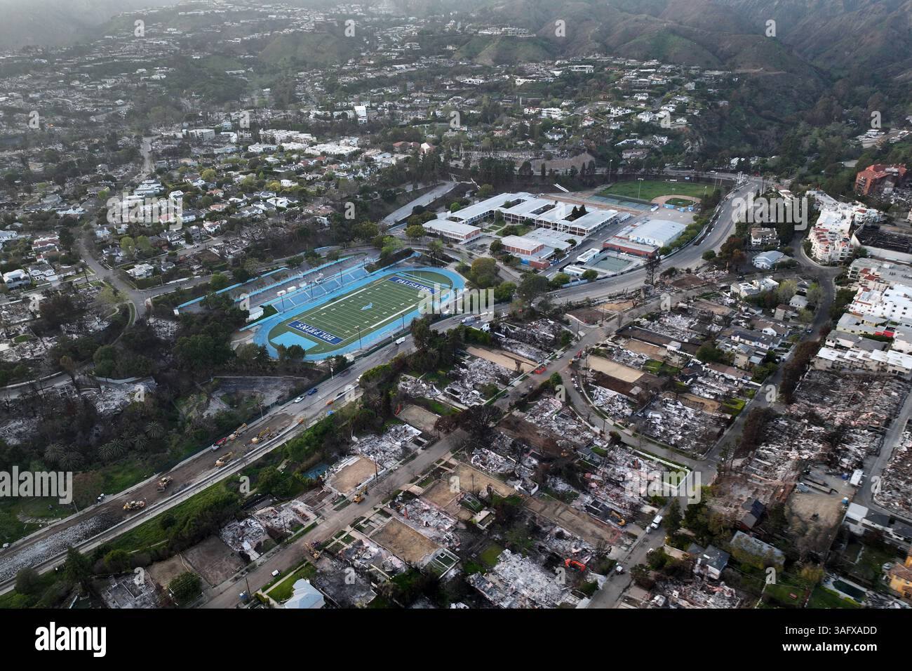 An aerial view of Palisades Charter High School and burned homes from ...
