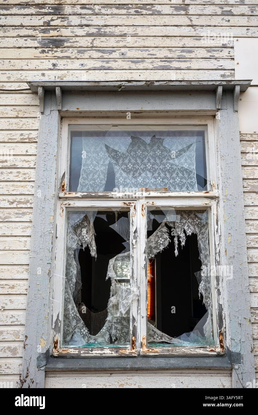 Broken windows of a derelict home Stock Photo - Alamy