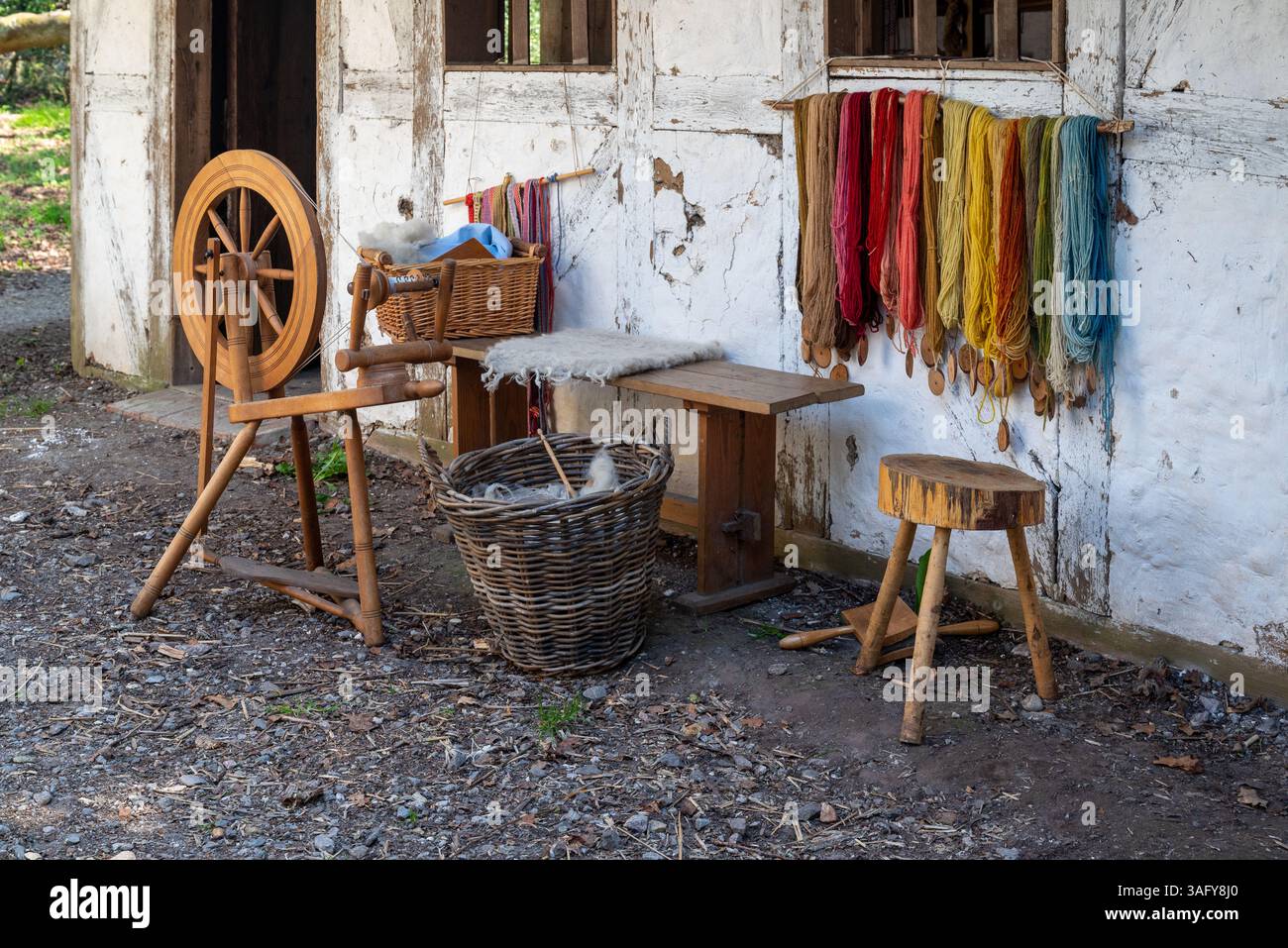 17th century spinning wheel and yarn of different colours at the Little ...