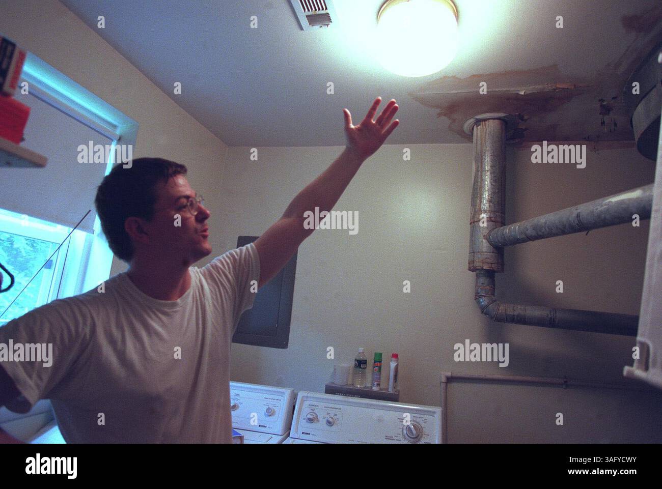 US Navy Petty Officer Third Class Gerald Scheffler, 26, points to a ...