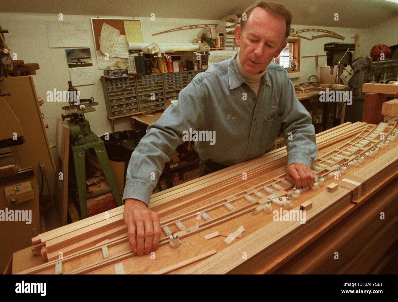 Ken Hyde shows how the wooden ribs of the wing are bent using a ...