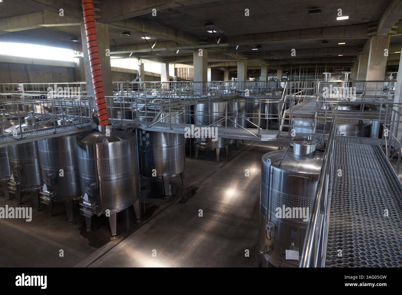 Inside a Chilean wine distillery, showcasing stainless steel tanks and ...