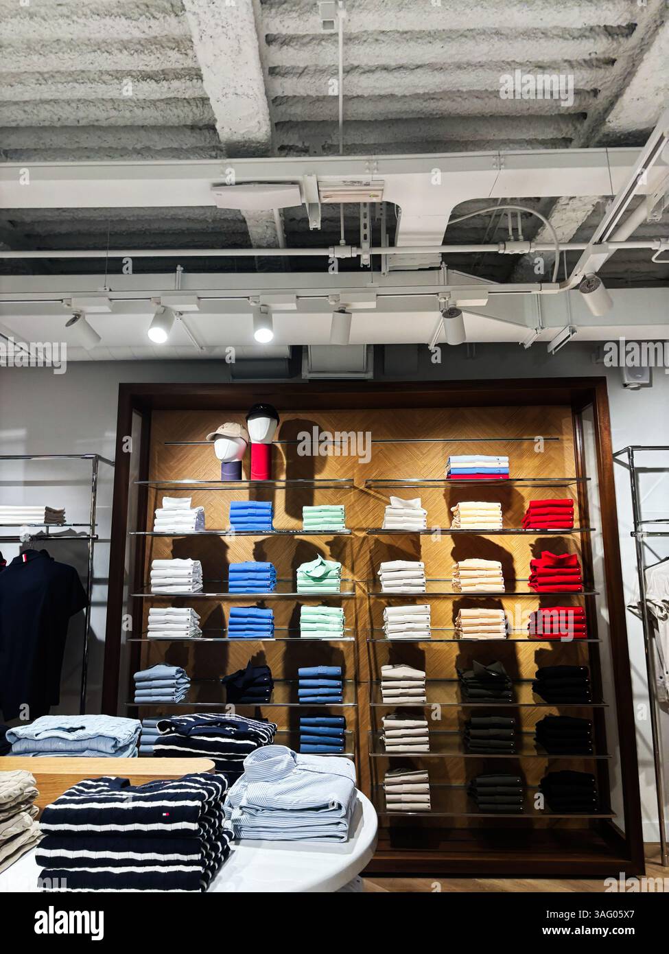 Milan, Italy - March 26, 2025: Neatly arranged clothing in a retail ...