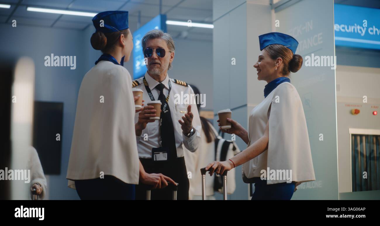 Airline Captain and Two Beautiful Stewardesses in Uniforms with ...