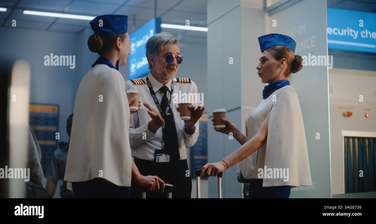 Airline Captain and Two Beautiful Stewardesses in Uniforms with ...