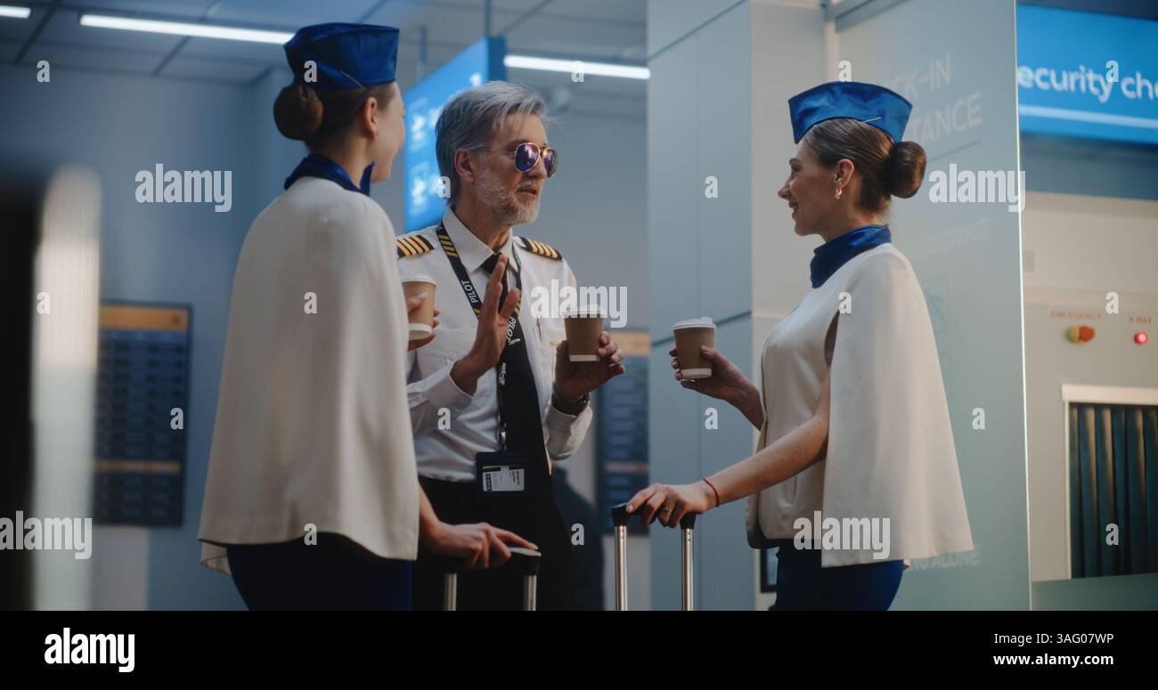 Airline Captain and Two Beautiful Stewardesses in Uniforms with ...