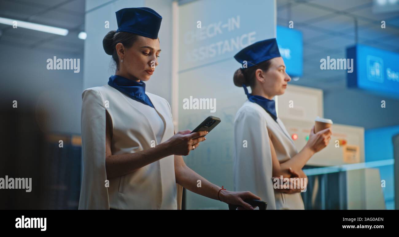 Two Beautiful Flight Attendants in Elegant Uniforms Talking, Waiting ...
