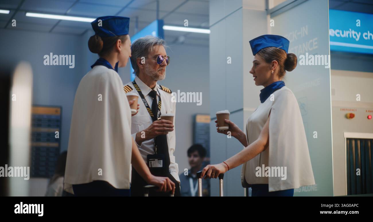 Airline Pilot and Two Beautiful Flight Attendants in Uniforms with ...