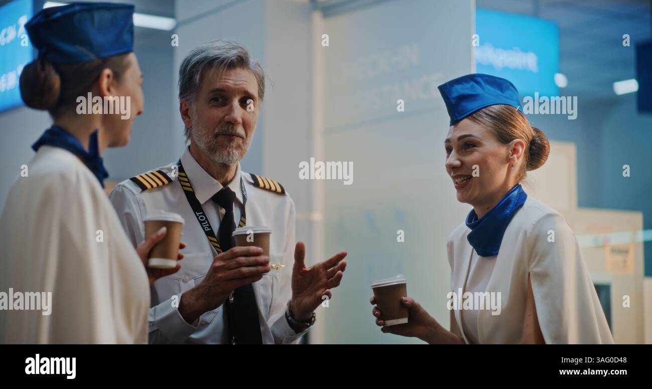 Flight Crew: Mature Airline Pilot Communicating with Two Beautiful ...