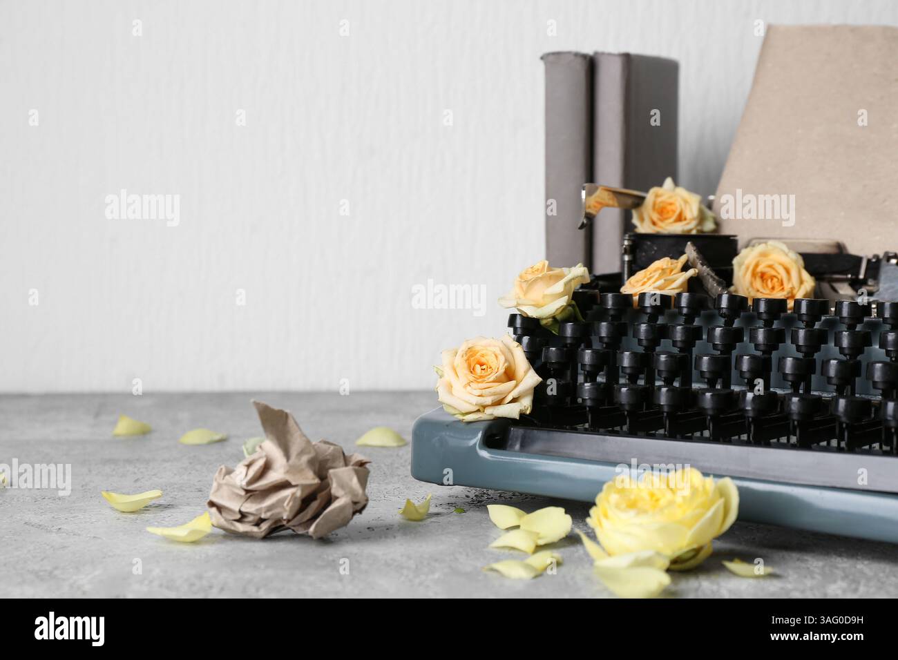 Vintage typewriter with craft paper, books and roses on grey grunge ...