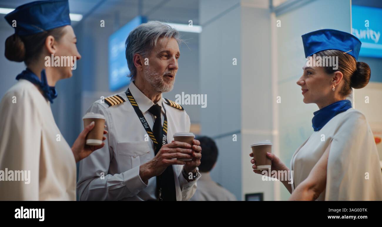 Flight Crew: Mature Airline Pilot Communicating with Two Beautiful ...
