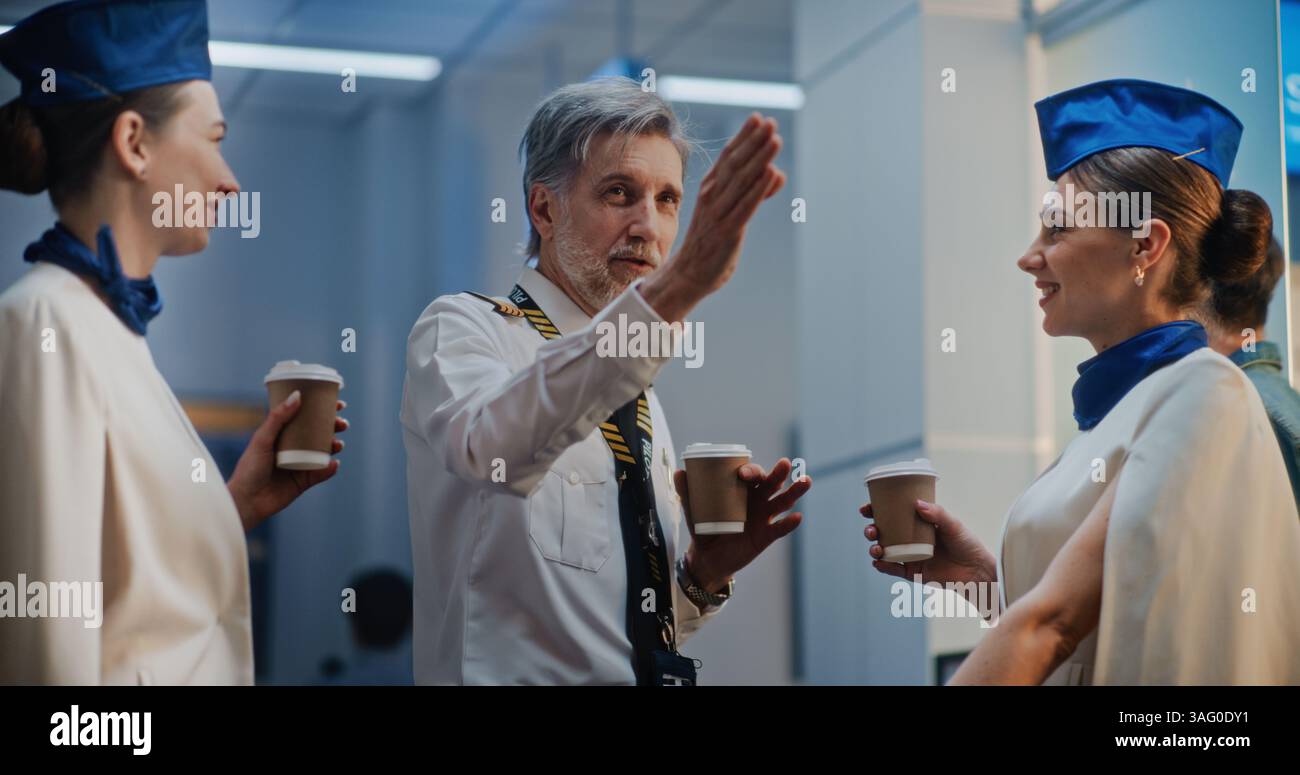 Flight Crew: Mature Airline Pilot Communicating with Two Beautiful ...