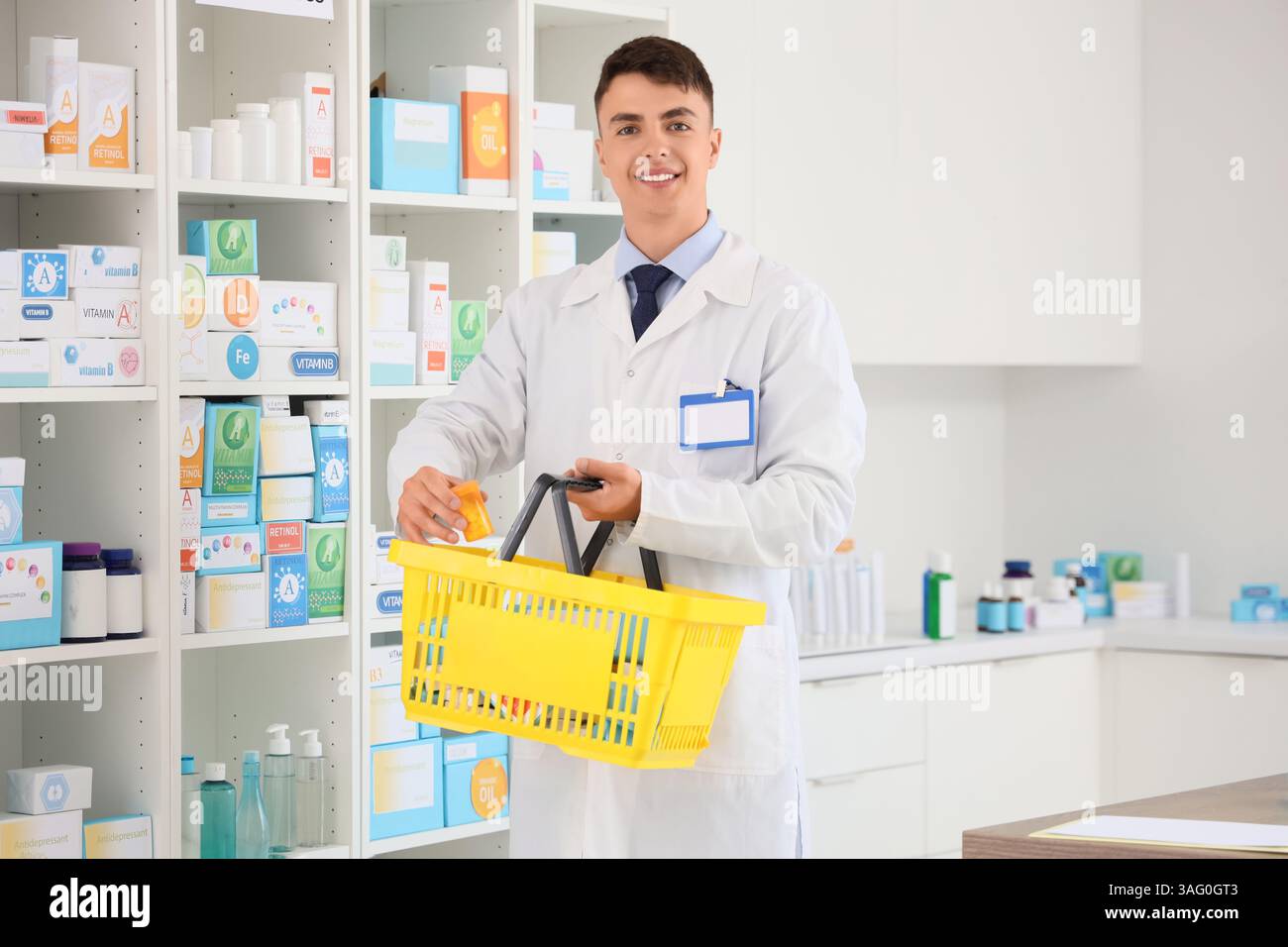 Male pharmacist packing order into basket at pharmacy Stock Photo - Alamy