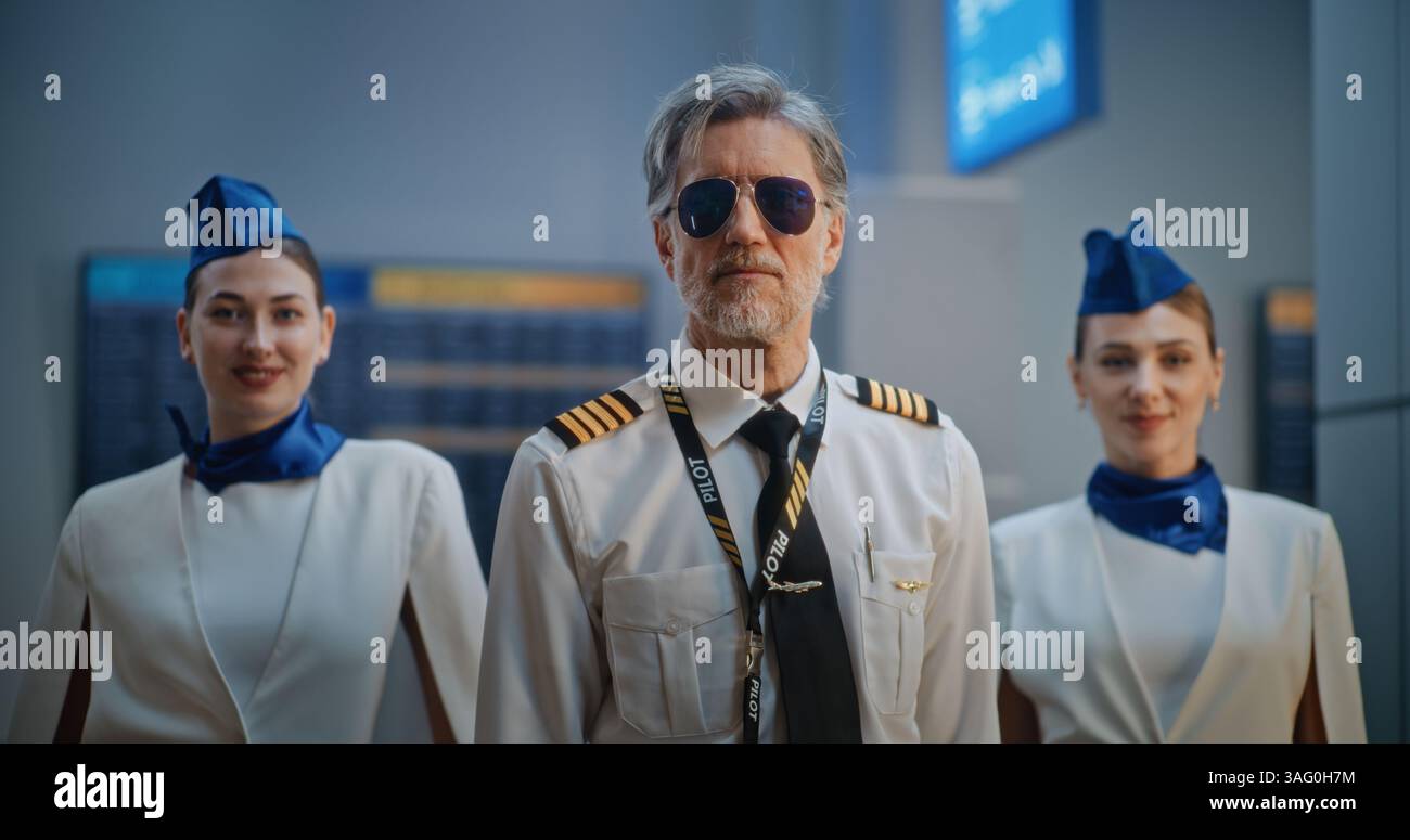 Portrait of Professional Airline Captain in Glasses, Two Beautiful ...