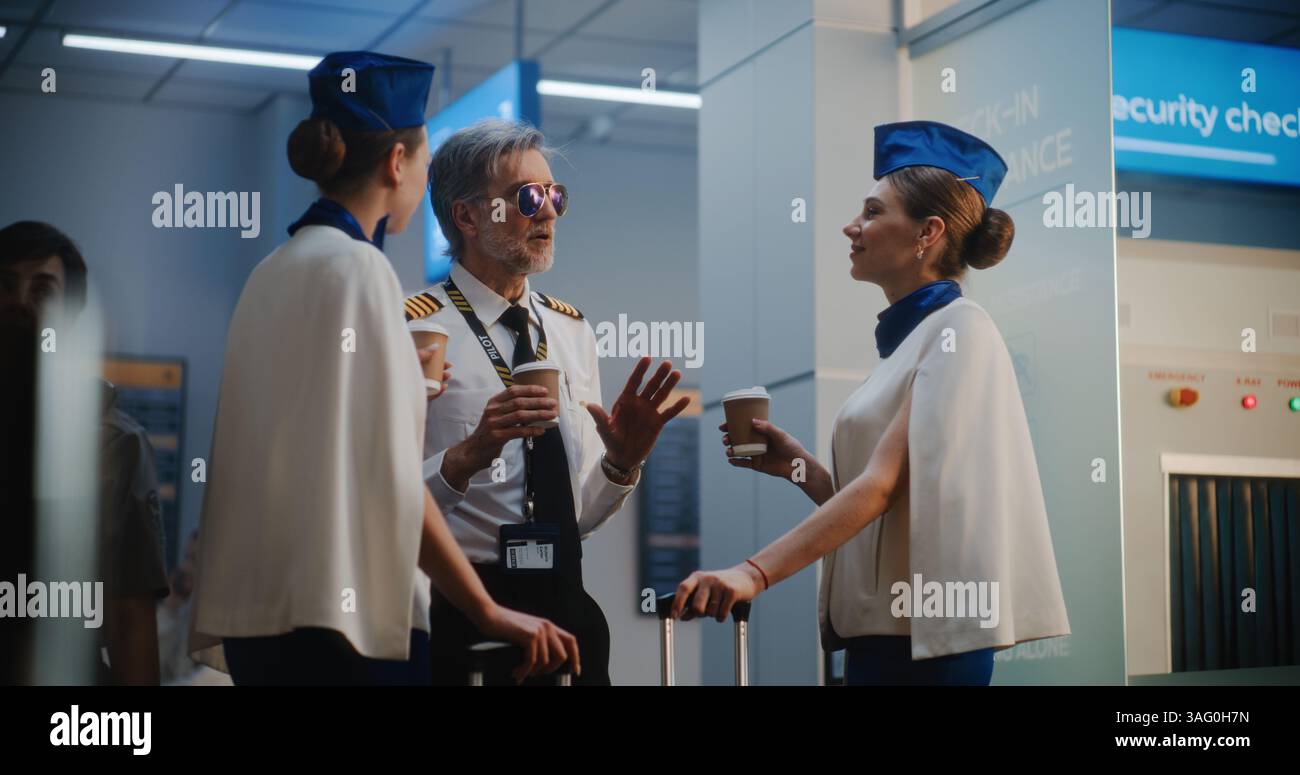 Airline Captain and Two Beautiful Stewardesses in Uniforms with ...