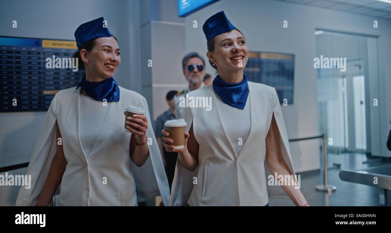 Crowded International Airport Terminal: Two Beautiful Flight Attendants ...