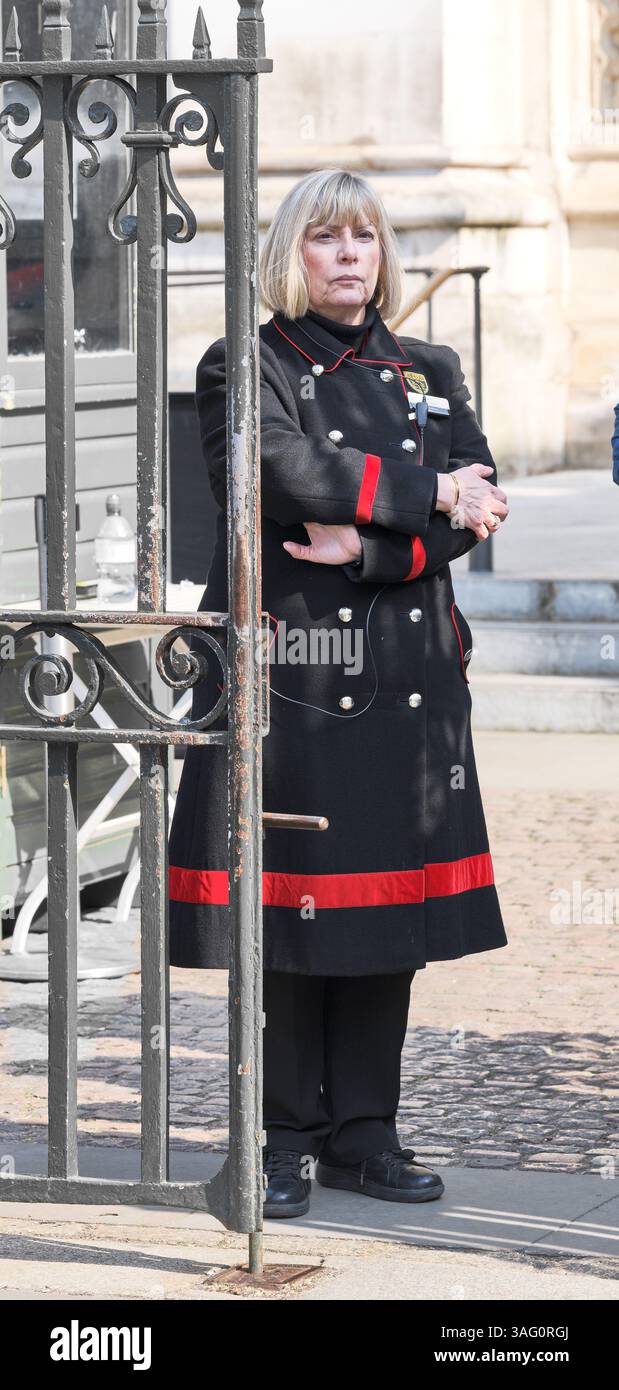 Female security guard in uniform at the exit from Westminster Abbey ...