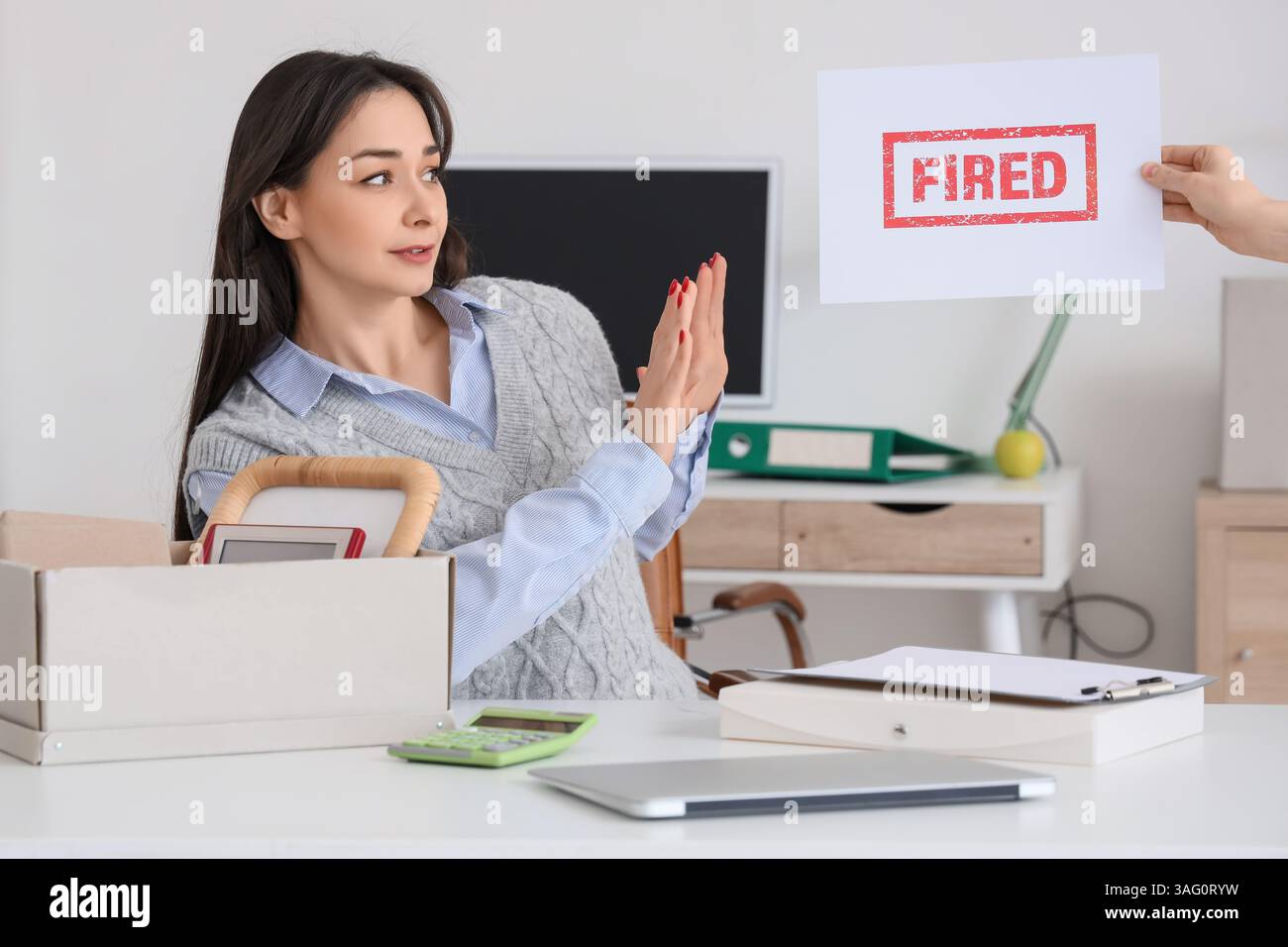 Businesswoman rejecting paper with word FIRED from hand in office Stock ...
