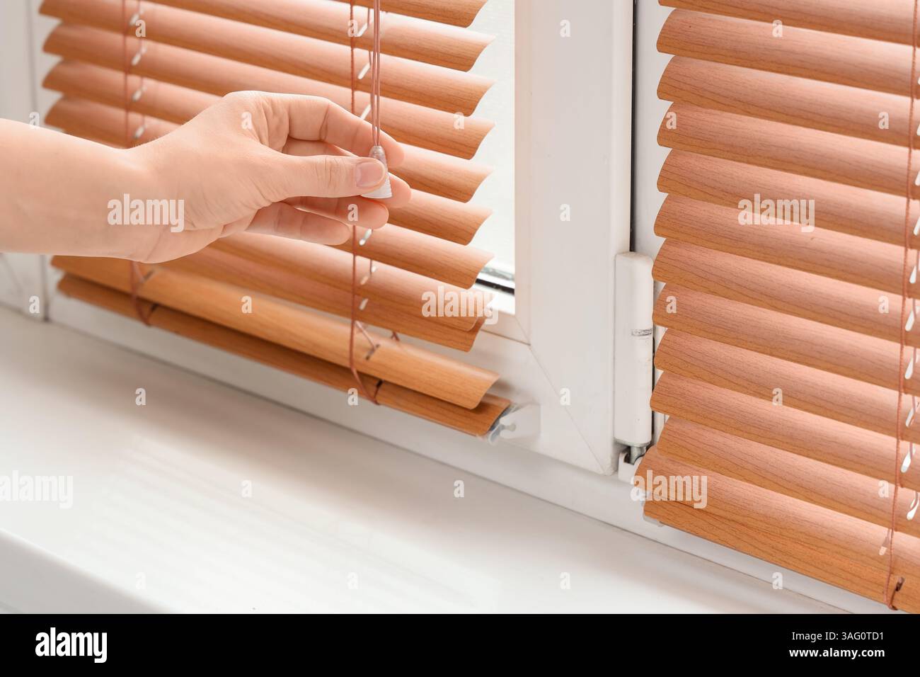 Female hand opening blinds in room, closeup Stock Photo - Alamy