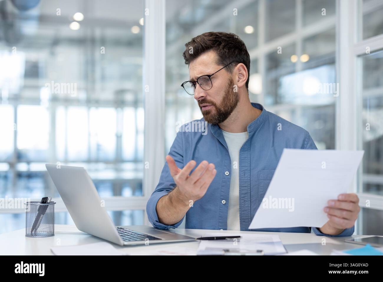 Frustrated business executive reading papers hi-res stock photography ...