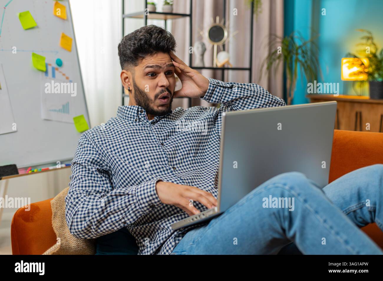Frustrated Indian Arabian man having software problems with laptop ...