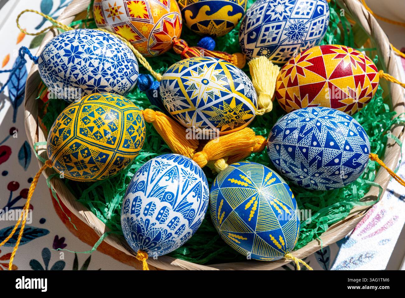 A woven basket brimming with beautifully crafted Easter eggs featuring ...