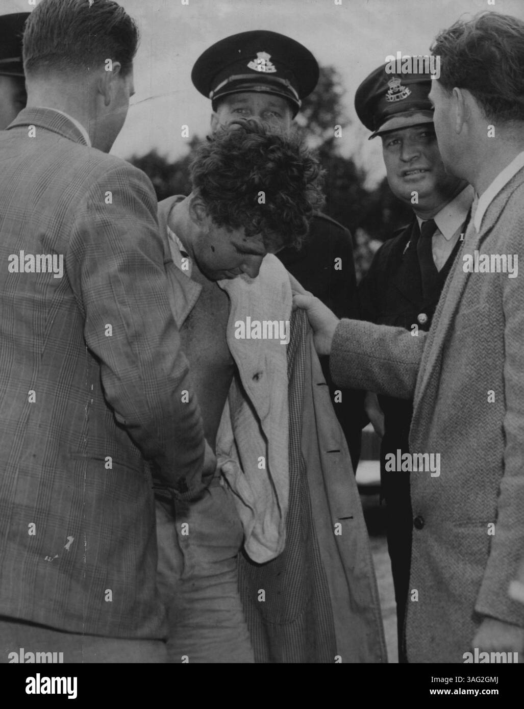 Brown is held firmly by detectives as he is brought from Bush "Anger's Hill. Bed -Aggled ...