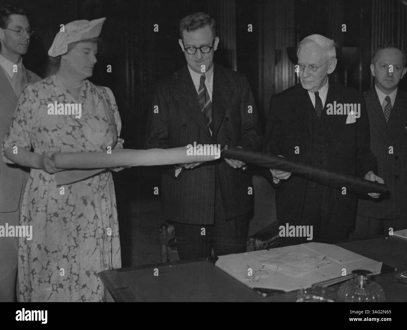 Mr. Calwell presents Australian cloth to Lord Addison. Picture Shows ...