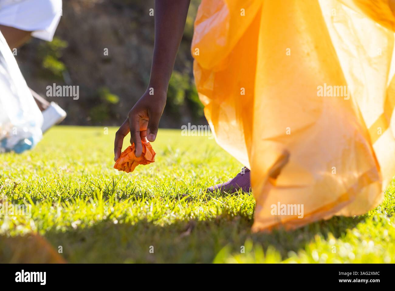 Picking up trash, african american girl in school uniform cleaning up ...