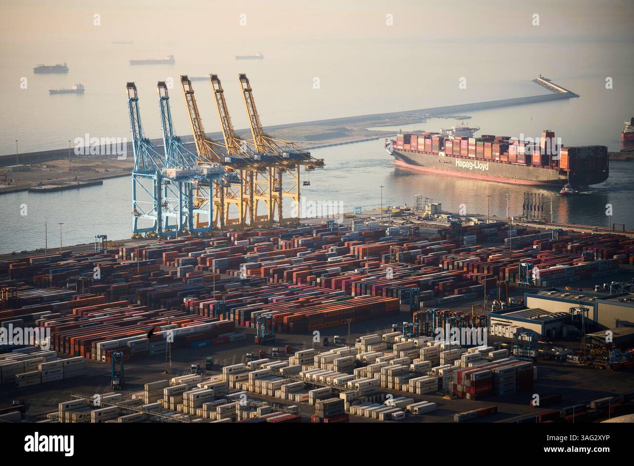 A cargo ship full of containers leaves the cargo terminal at the port ...