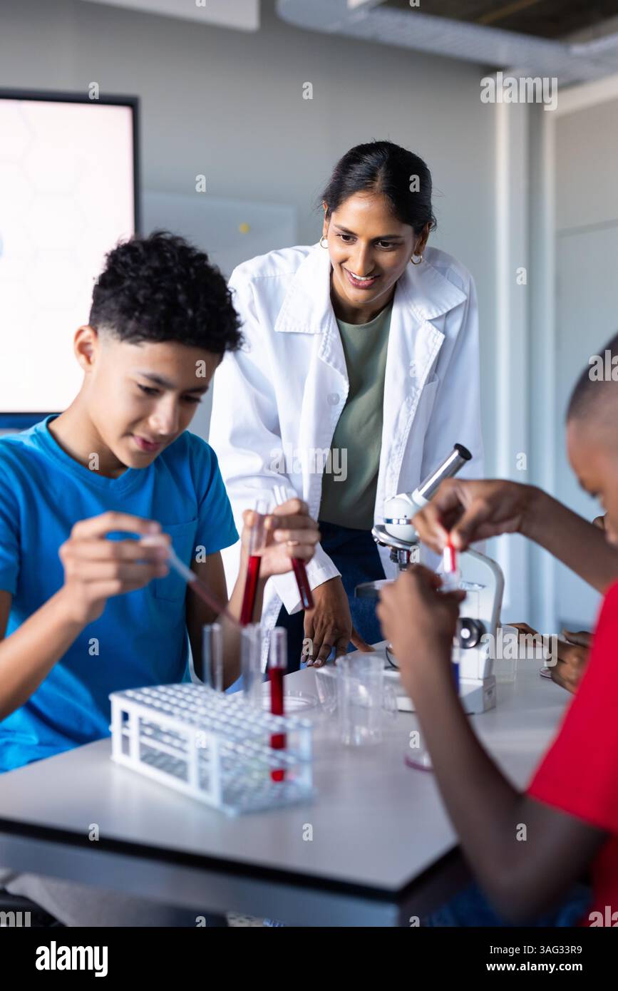 In school, students conducting science experiment with test tubes and ...