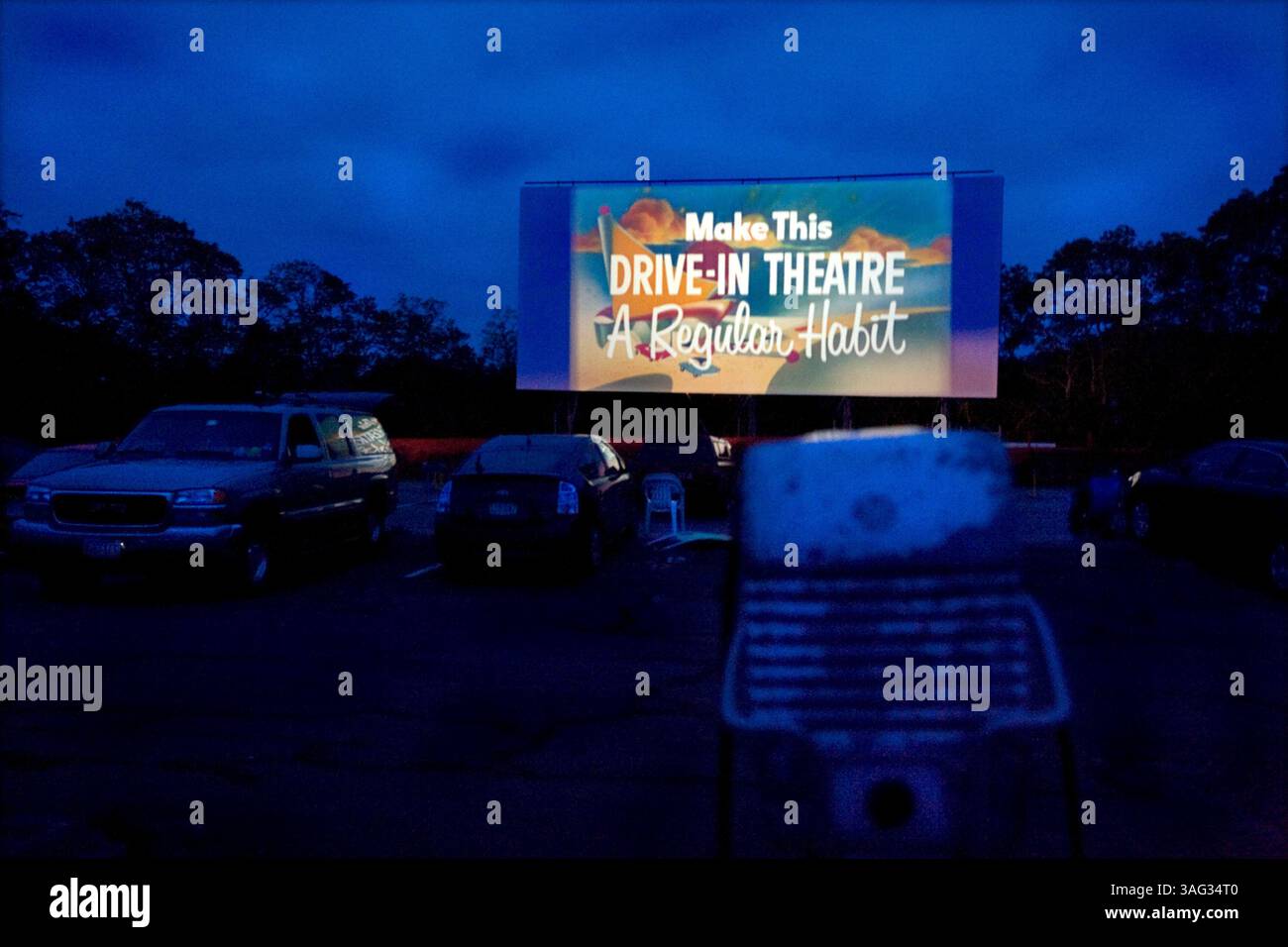 Visitors can watch a movie on the 100' x 44' outdoor screen and hear ...