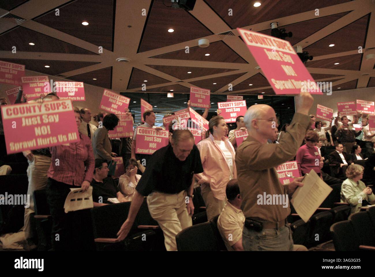 Environmentals shows their red signs asking to stop sprawl. Developer ...