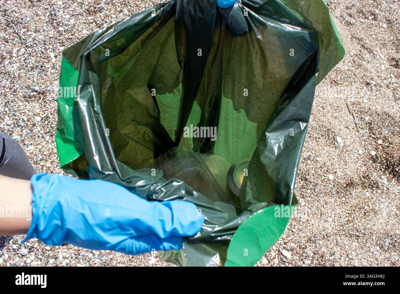 Open garbage bag with different garbage in hands Stock Photo - Alamy