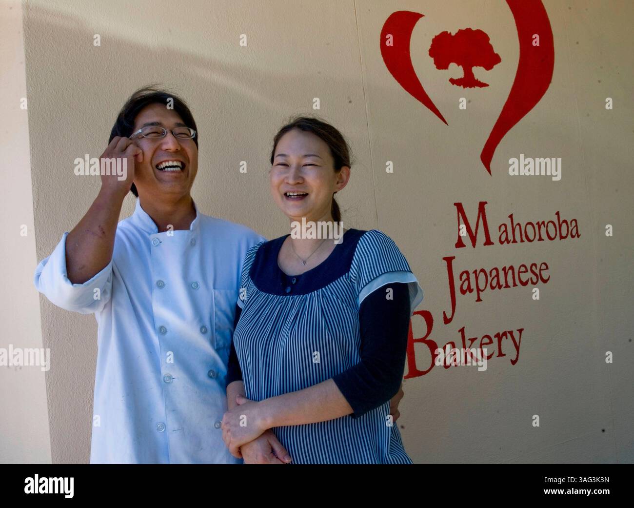 Business owner Narusuke Monguchi, left and his wife Yumie Monguchi pose ...