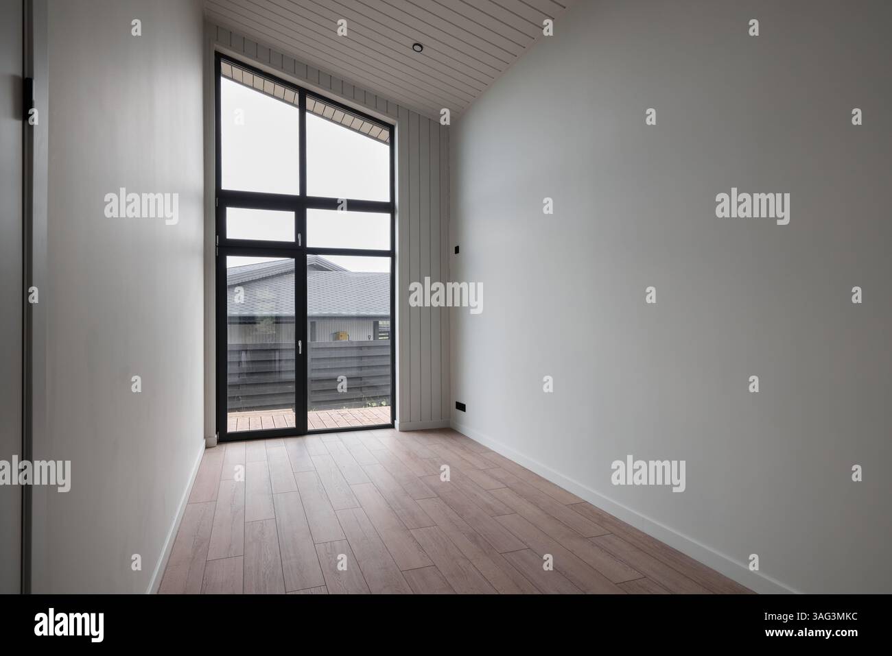 A Modern Minimalist Room Featuring Large Window Views That Enhance the ...