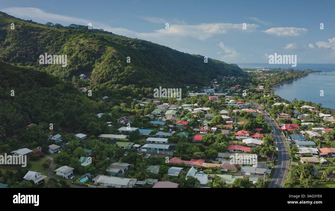 Aerial drone view captures the vibrant colors of a coastal town nestled ...