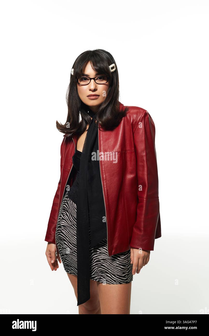 A young Asian woman showcases her trendy outfit with bold colors and ...