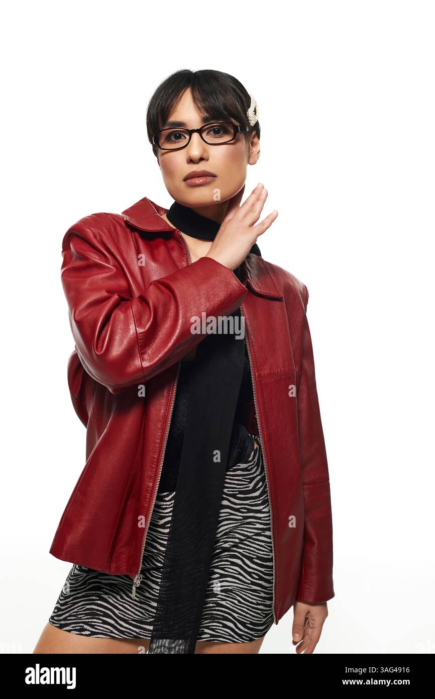 Confident young Asian woman in a bold red jacket shows off her unique ...