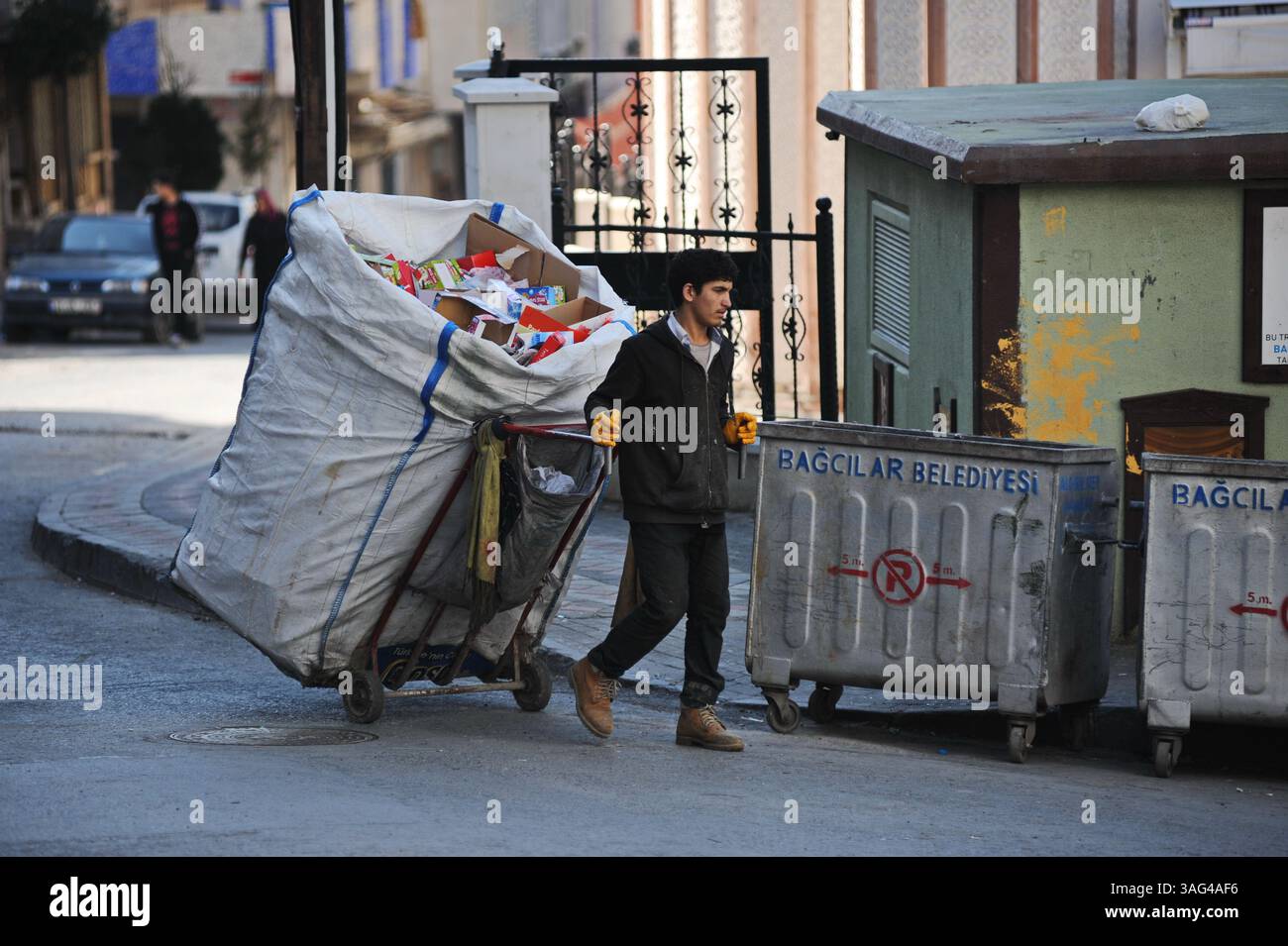 A man is pushing a cart with garbage Stock Photo - Alamy