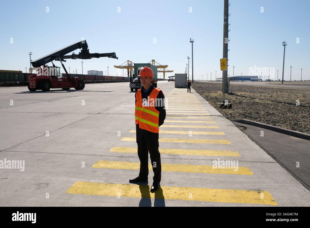 A security and control officer monitors the unloading of containers ...