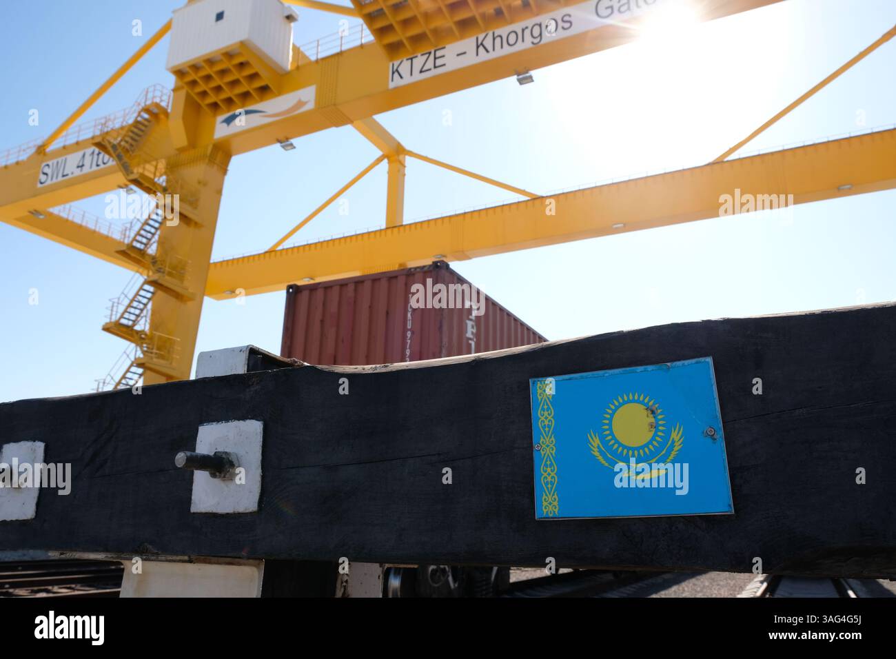 Unloading containers at the logistics center. Machines and cranes drag ...