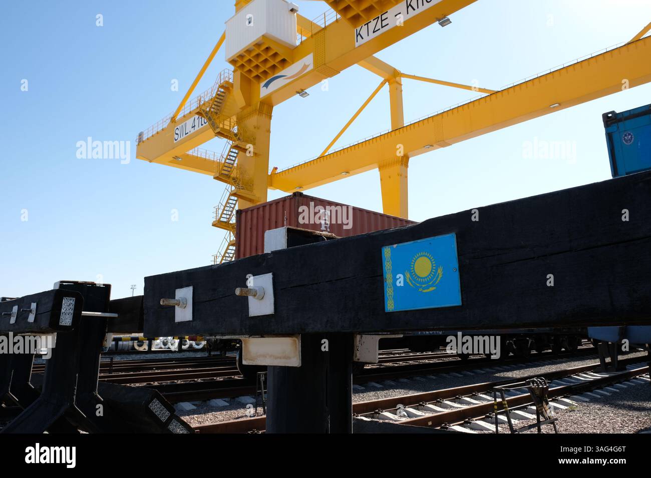 Unloading containers at the logistics center. Machines and cranes drag ...