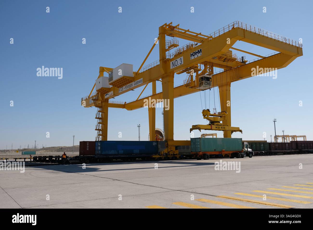 Unloading containers at the logistics center. Machines and cranes drag ...