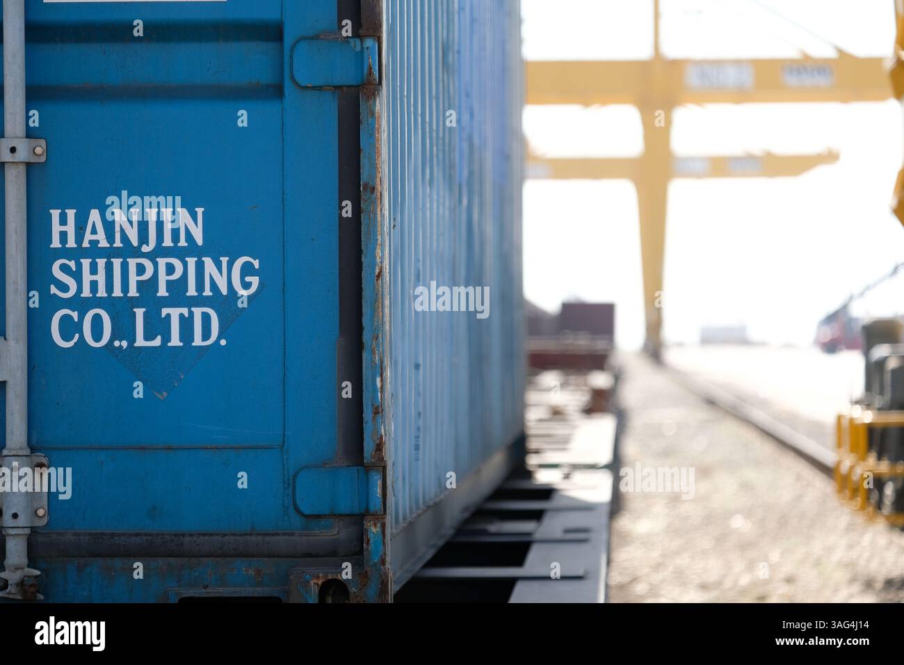 Unloading containers at the logistics center. Machines and cranes drag ...